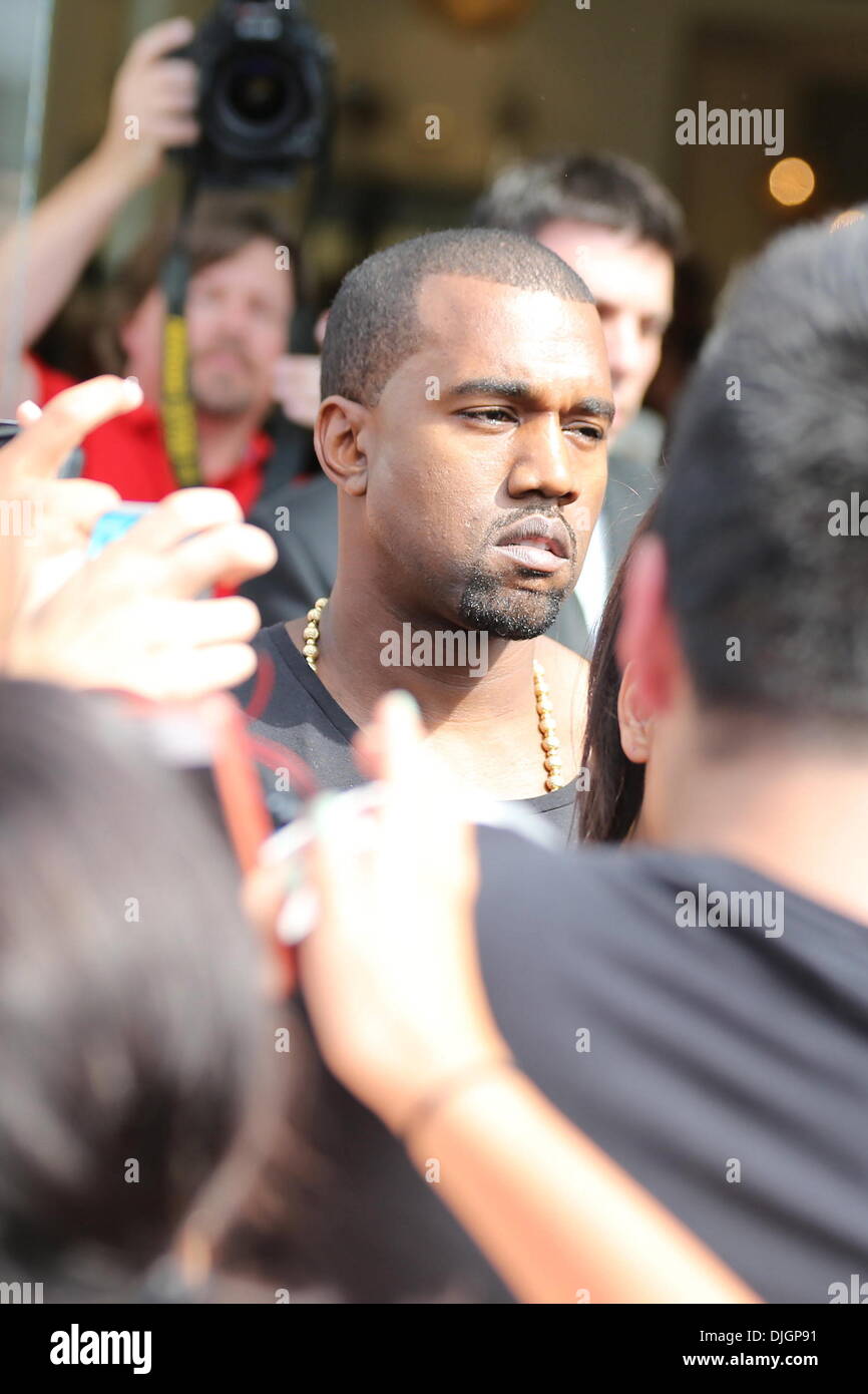 Kim Kardashian and boyfriend Kanye West attend the grand opening for ...