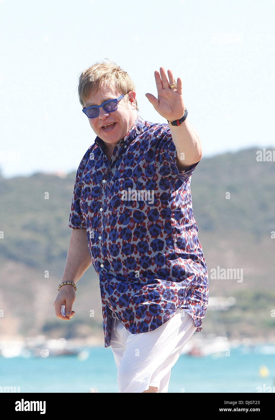 Elton John heads to Club 55 for lunch during a holiday with friends in ...