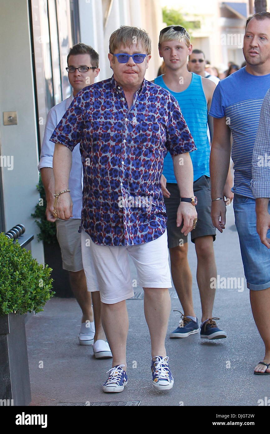 Elton John heads to Club 55 for lunch during a holiday with friends in ...