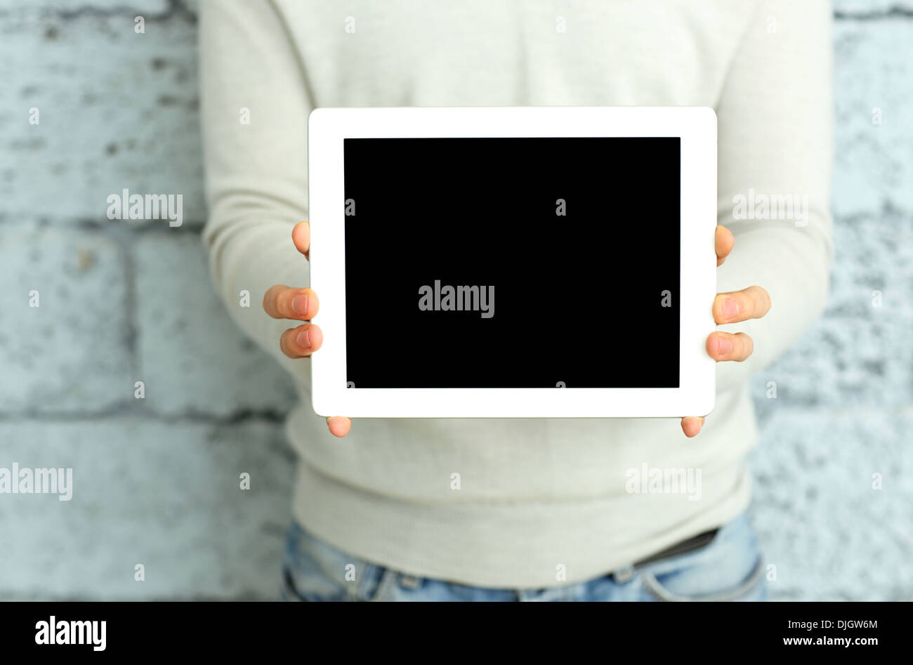 Closeup image of male hands showing display of tablet computer near the ...