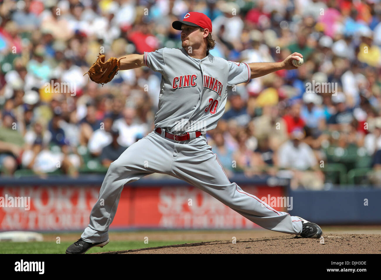 Winning pitcher Travis Wood (#30) of the Reds delivers a pitch during ...