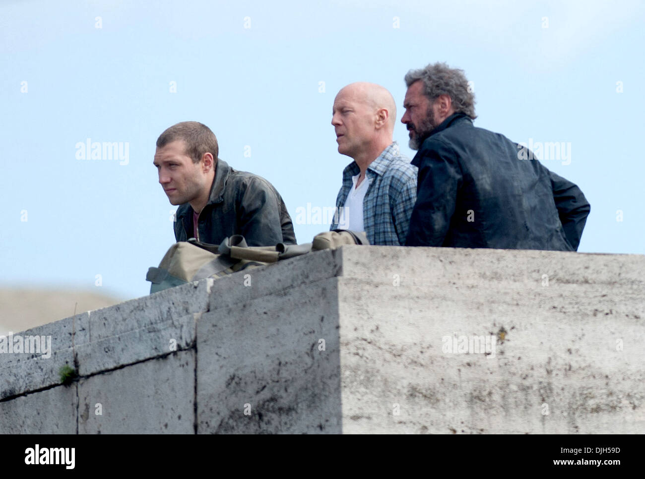 Jai Courtney Bruce Willis and Sebastian Koch shooting a scene on film ...