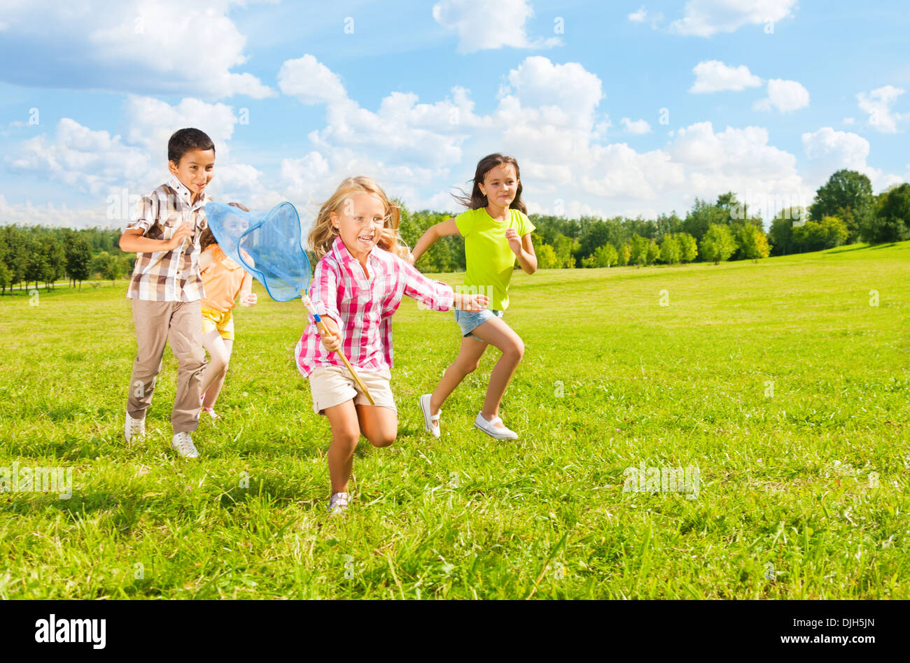 Kids chasing butterfly with the net, boys and girls, diversity looking ...