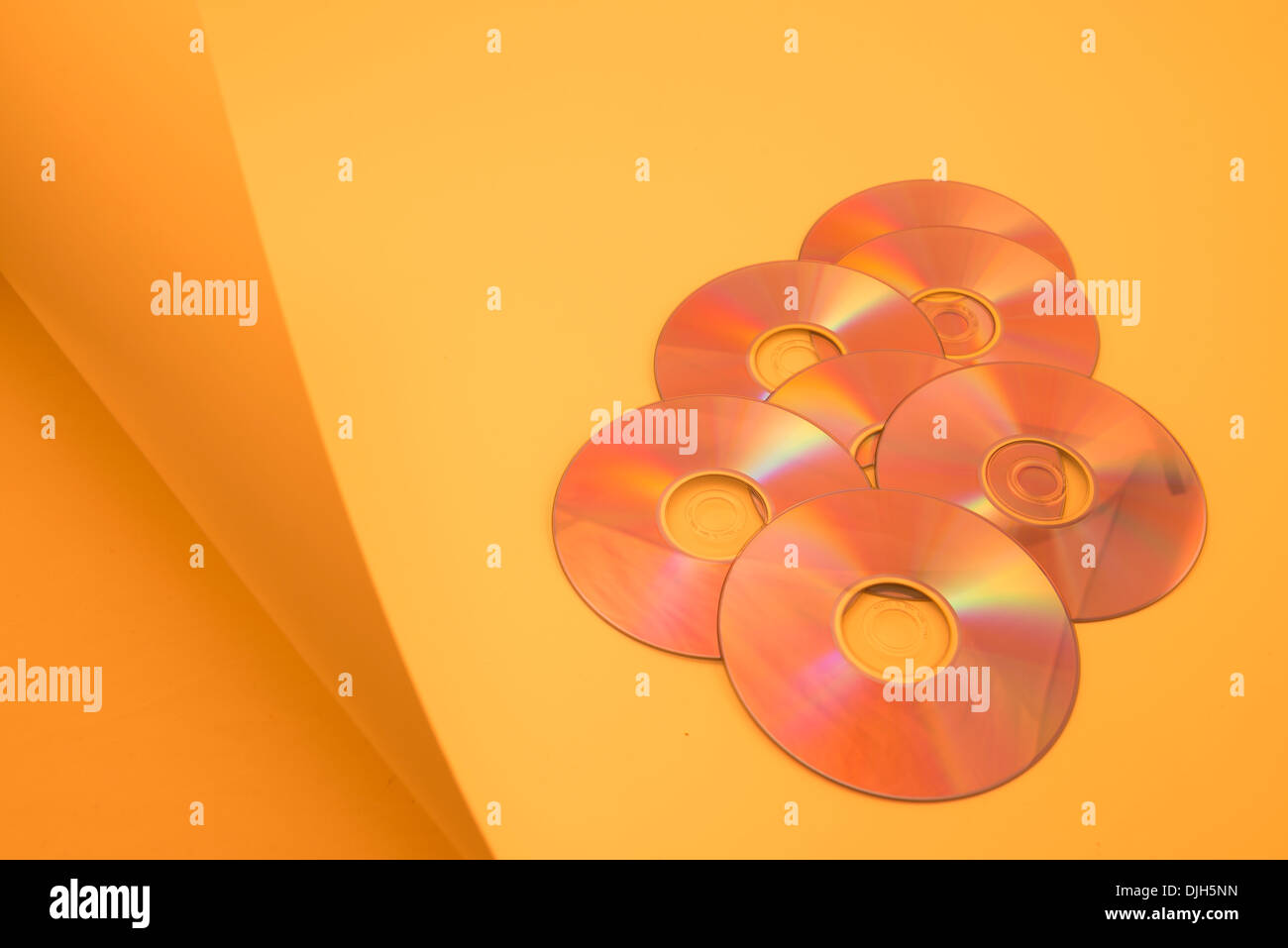 six dvd on yellow background Stock Photo - Alamy