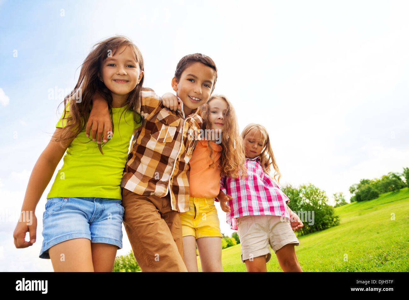 Group of hugging 6 ,7 years kids standing and hugging in the park on ...