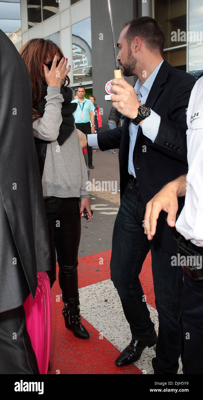 Cheryl Cole tries to stay hidden as she arrives at Nice Airport for the ...