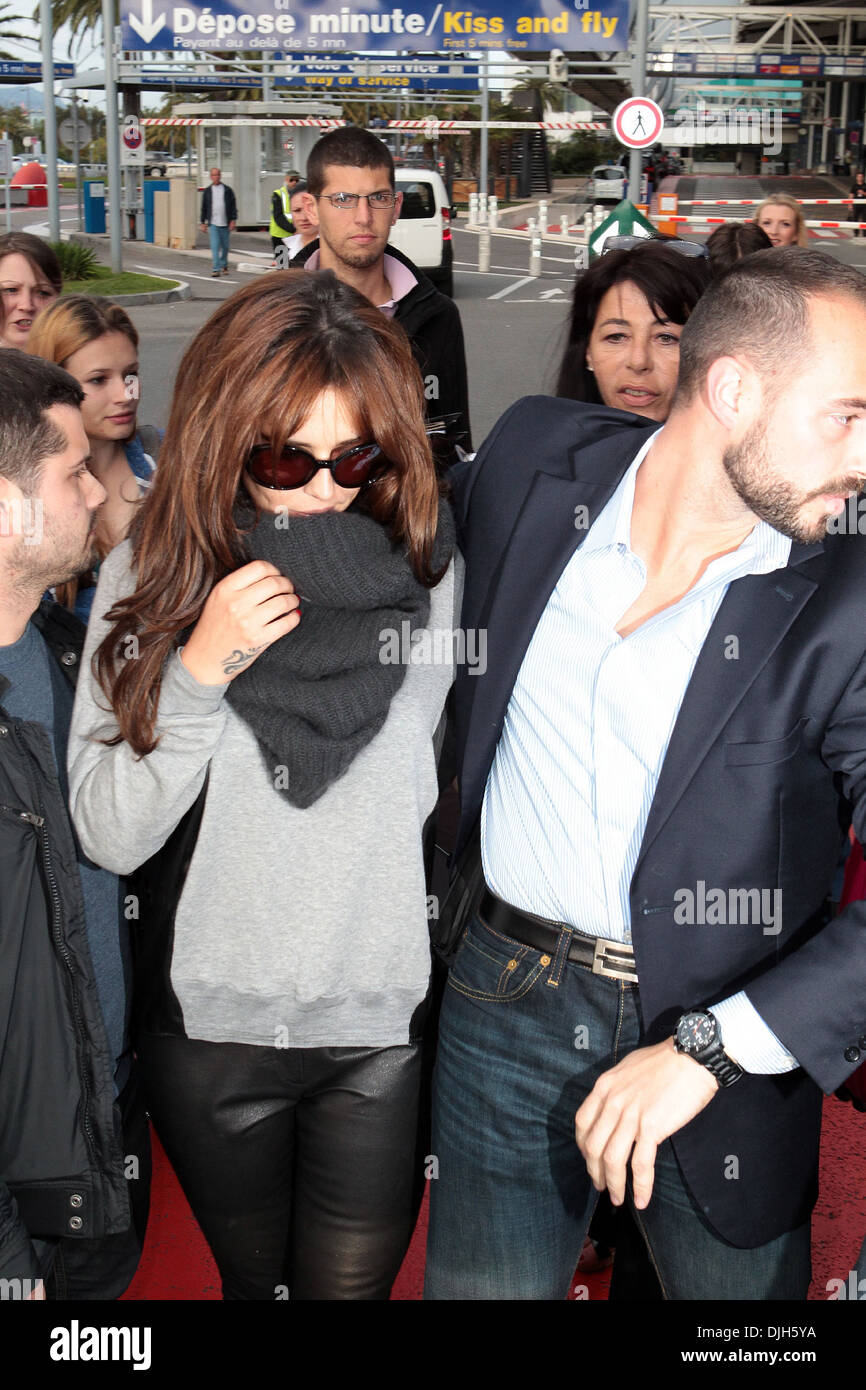 Cheryl Cole tries to stay hidden as she arrives at Nice Airport for the ...