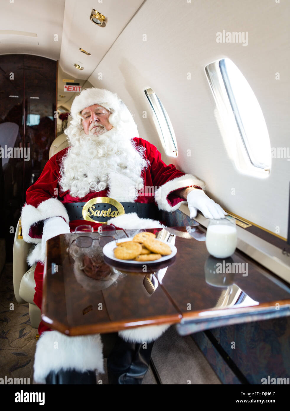 Santa With Eyes Closed Relaxing In Private Jet Stock Photo - Alamy