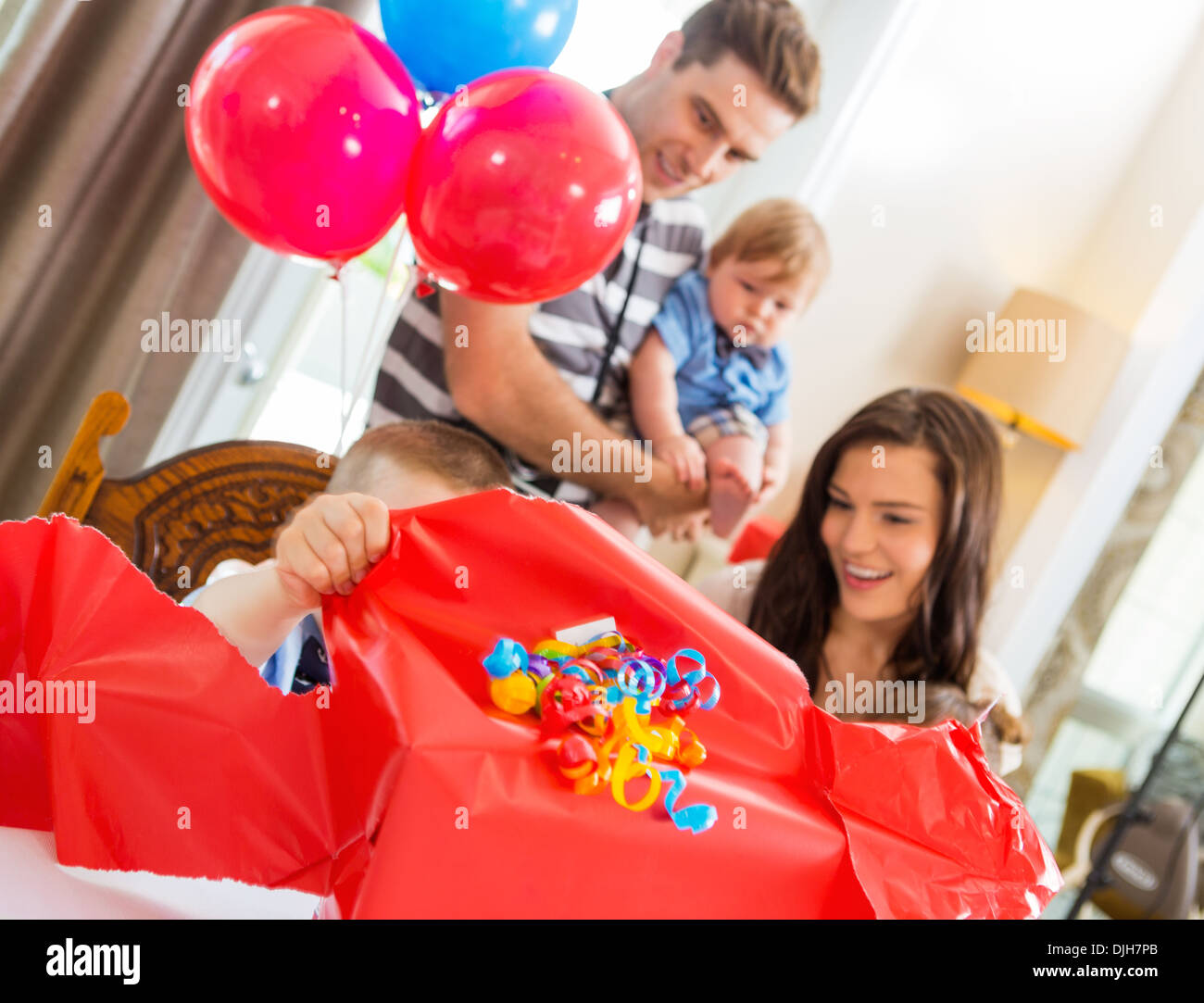 Birthday Boy Opening Gift Box Stock Photo - Alamy