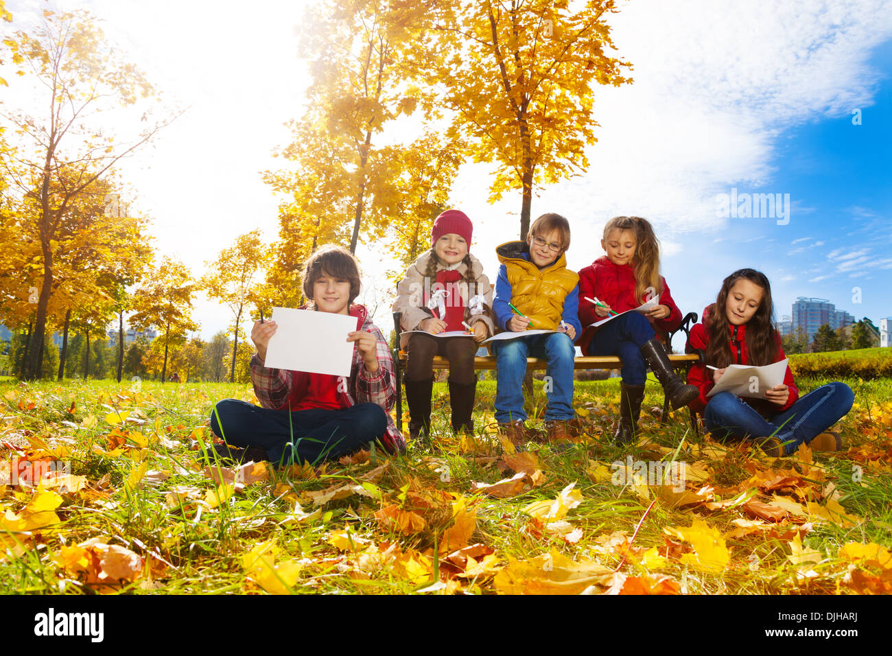 Kids playing under maple tree in autumn hi-res stock photography and ...