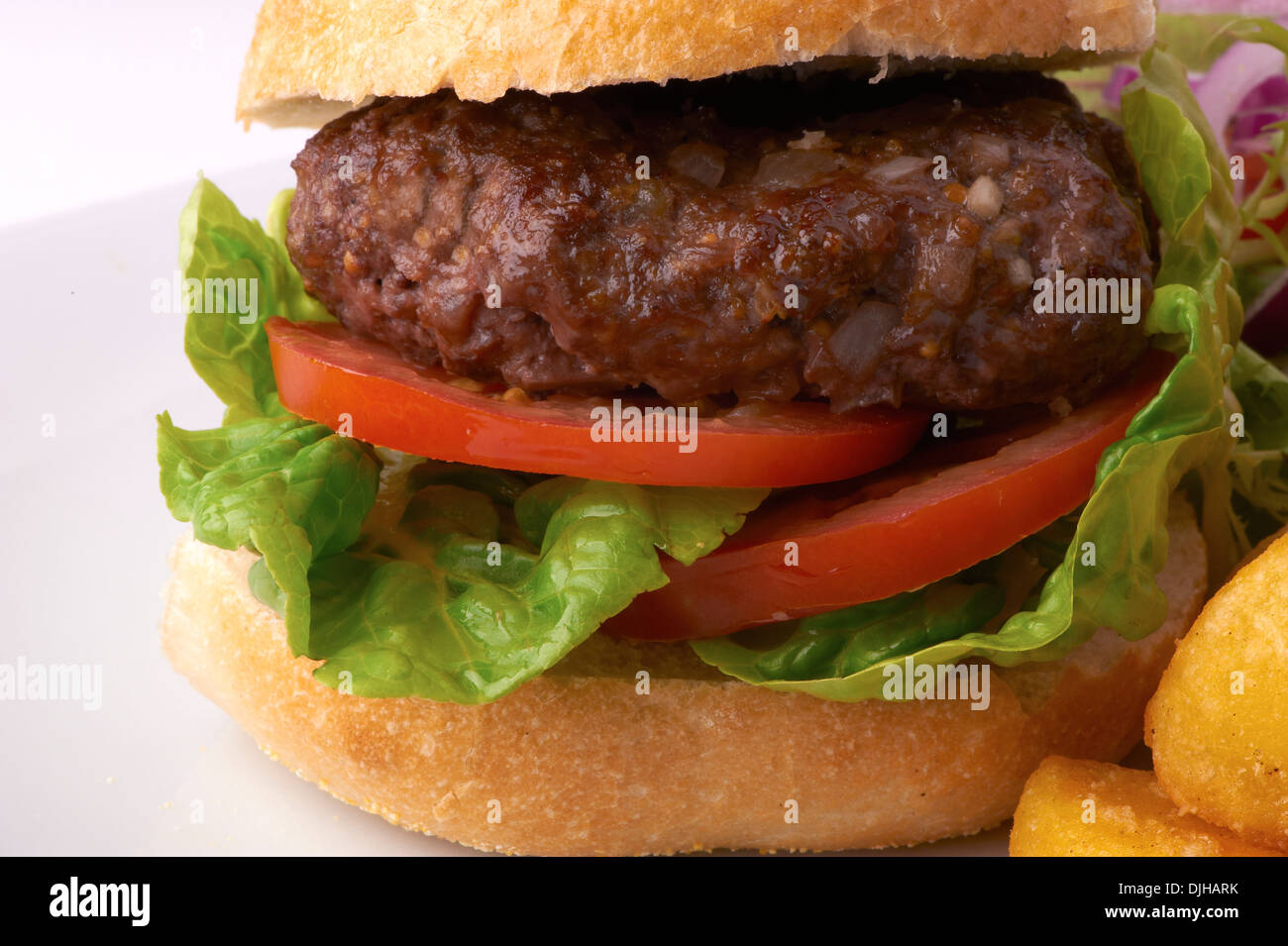 Beef Burger in a bun with chips Stock Photo - Alamy