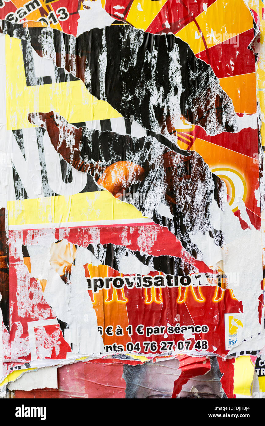 Torn posters on a wall Stock Photo - Alamy