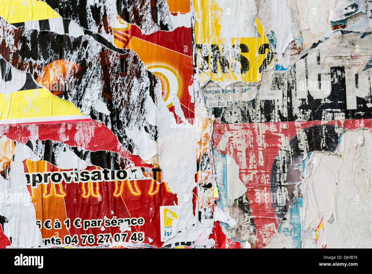 Torn posters on a wall Stock Photo - Alamy