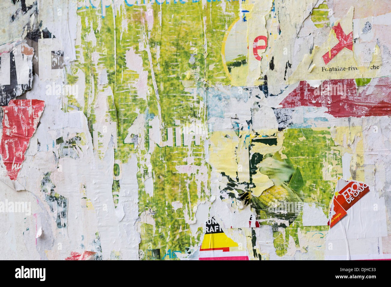 Torn posters on a wall Stock Photo - Alamy