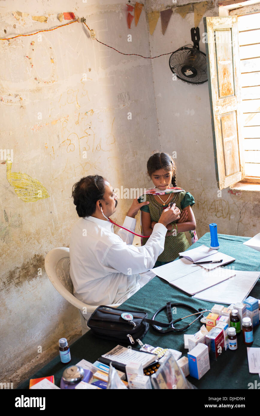 Indian Pediatric doctor examining a young girl at Sri Sathya Sai Baba ...