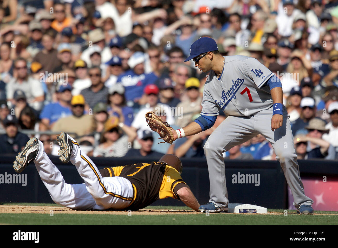 Padres Chase Headley slides safe under a tag by Dodgers first baseman ...