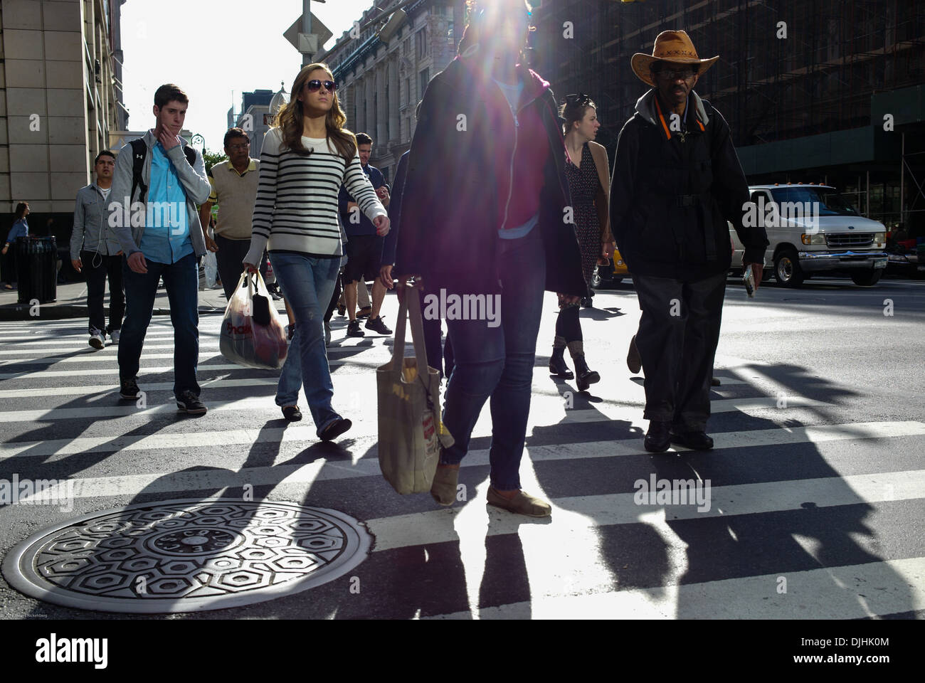 Pedestrians cross an intersection in mid-town Manhattan, New York Stock ...