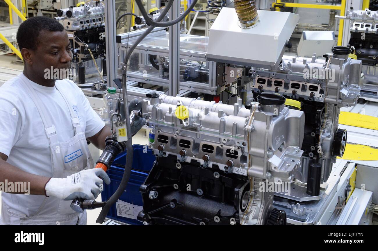 Volkswagen Saxony employee Mathias Tesoura assembles an engine in the ...