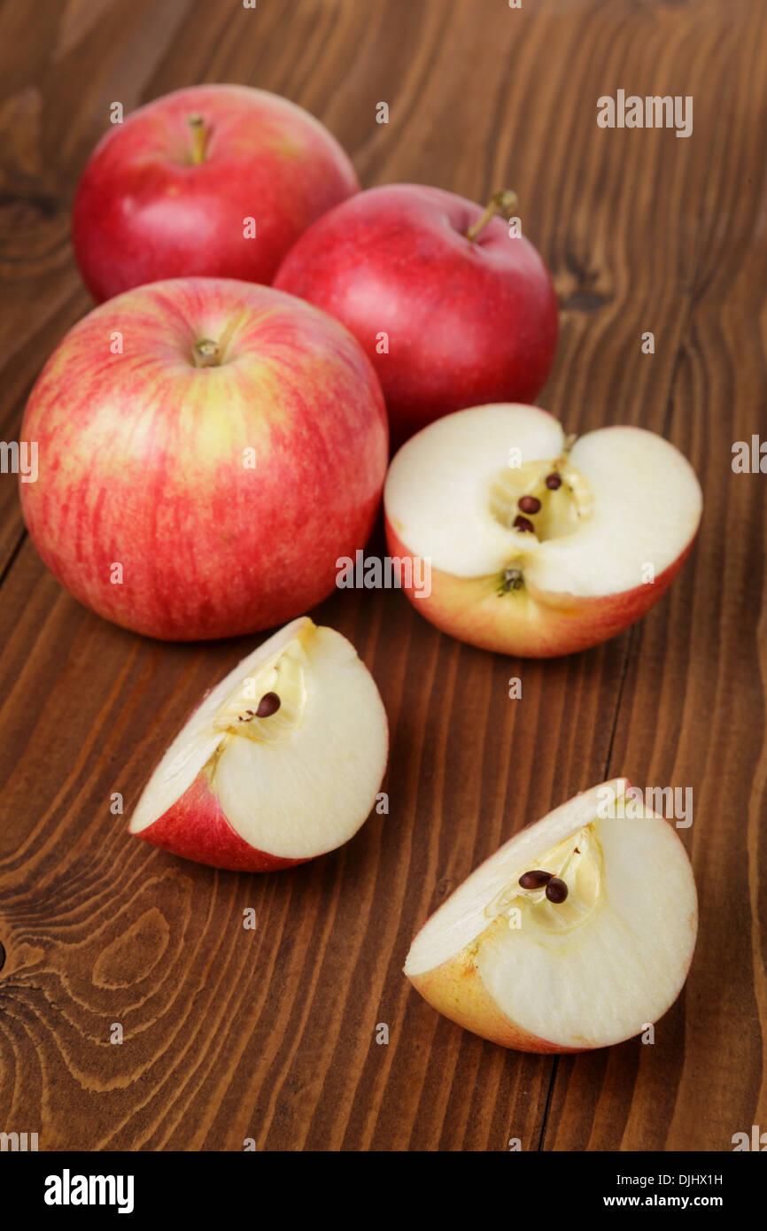 ripe red apples on wood table, with slices Stock Photo - Alamy