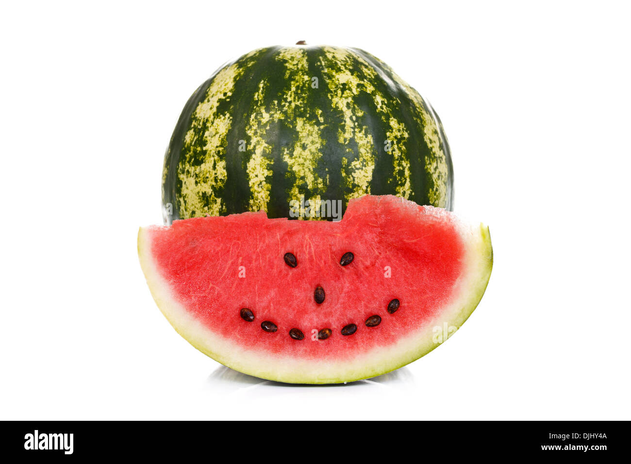 A whole watermelon with a slice of it having seeds in smiley form Stock ...