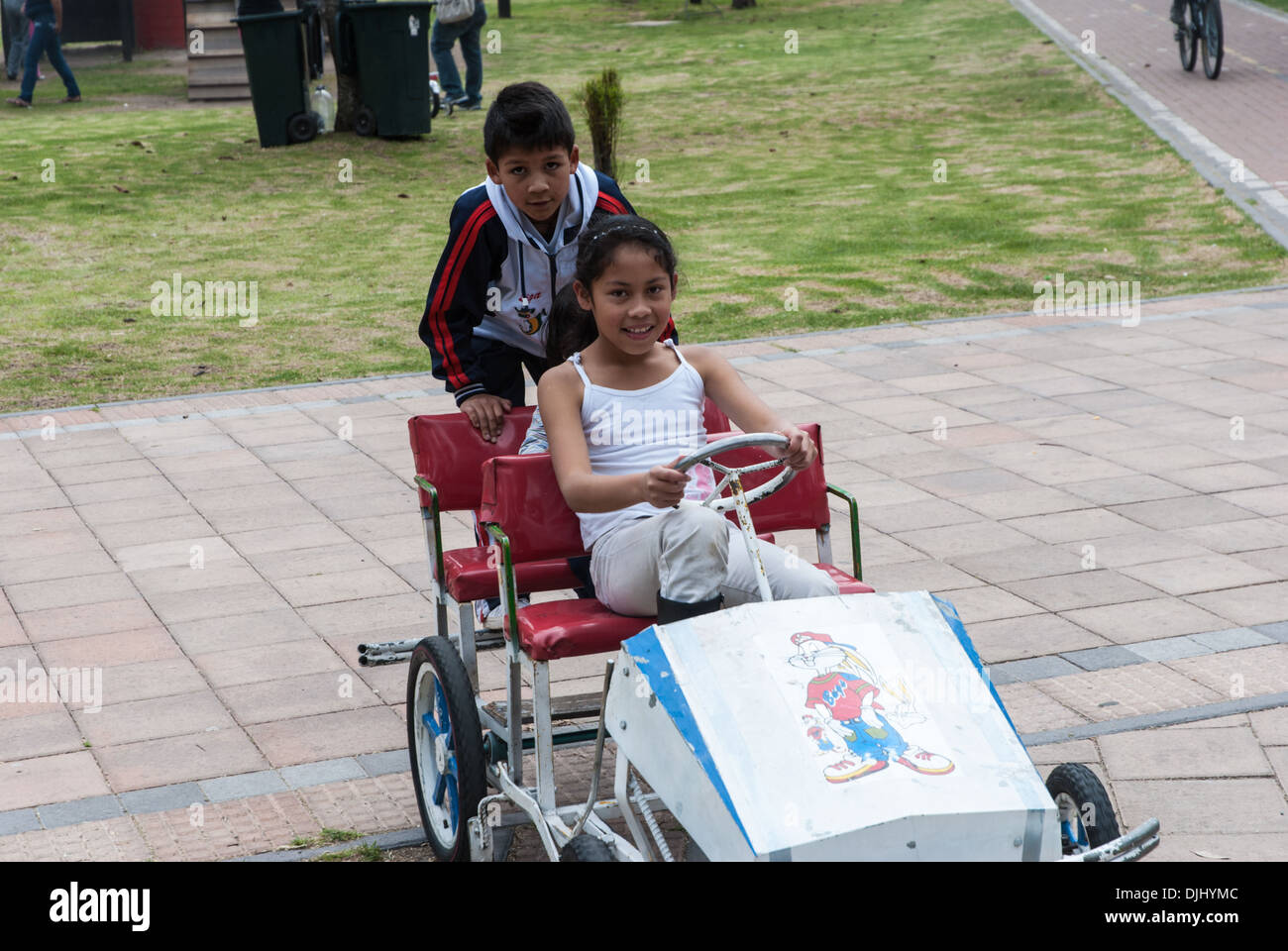 Two children playing in a go-cart Stock Photo - Alamy