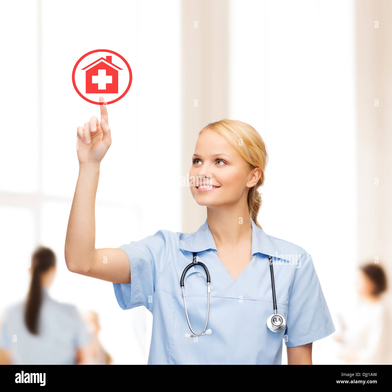 smiling doctor or nurse pointing to hospital icon Stock Photo - Alamy