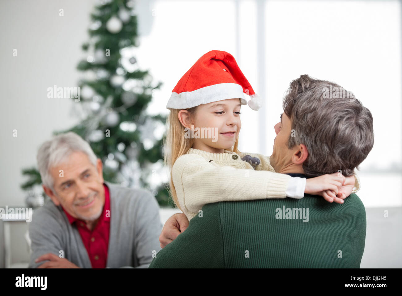 Girl Embracing Father During Christmas Stock Photo - Alamy