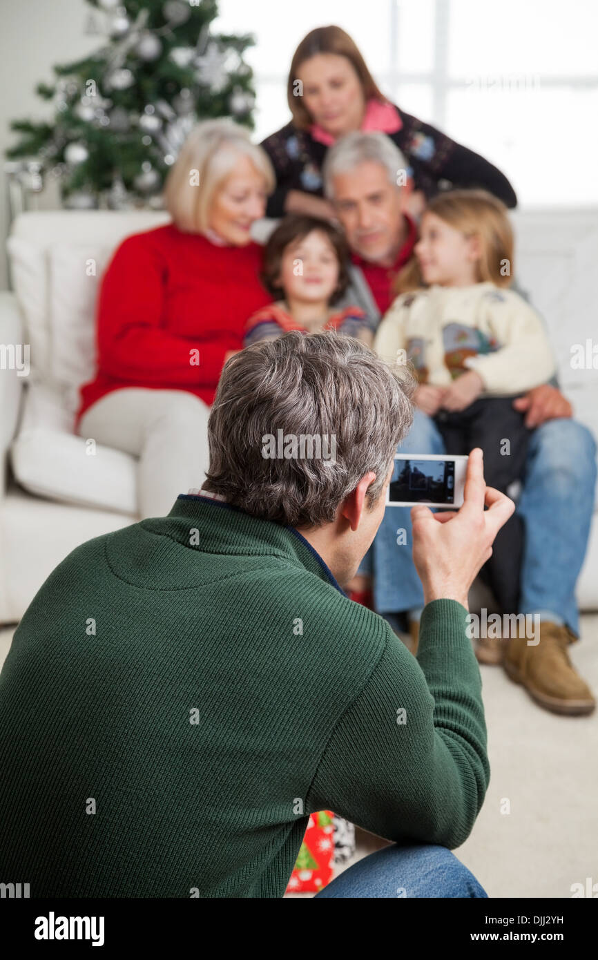 Man Photographing Family Through Smartphone Stock Photo - Alamy