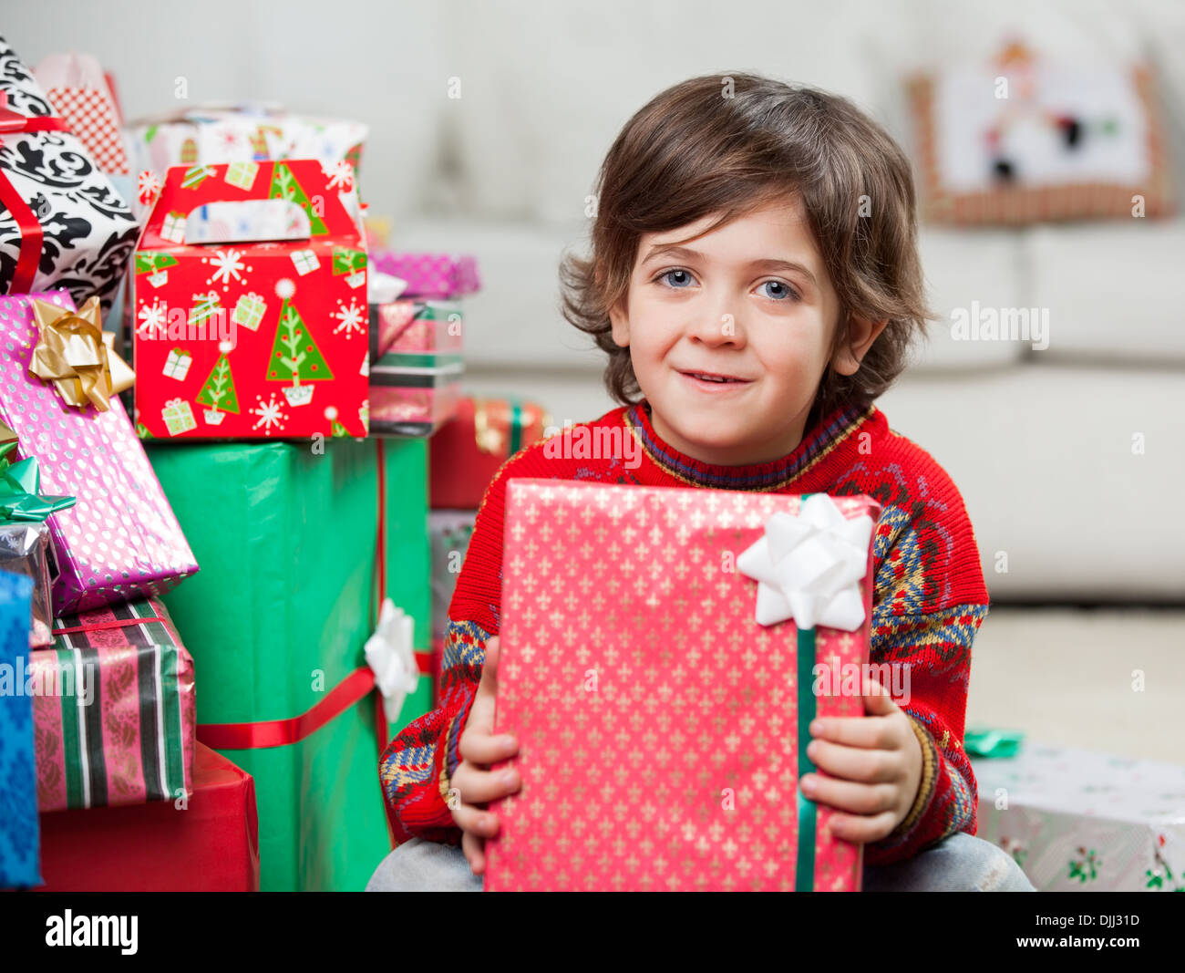 Cute Boy With Holding Christmas Present Stock Photo - Alamy