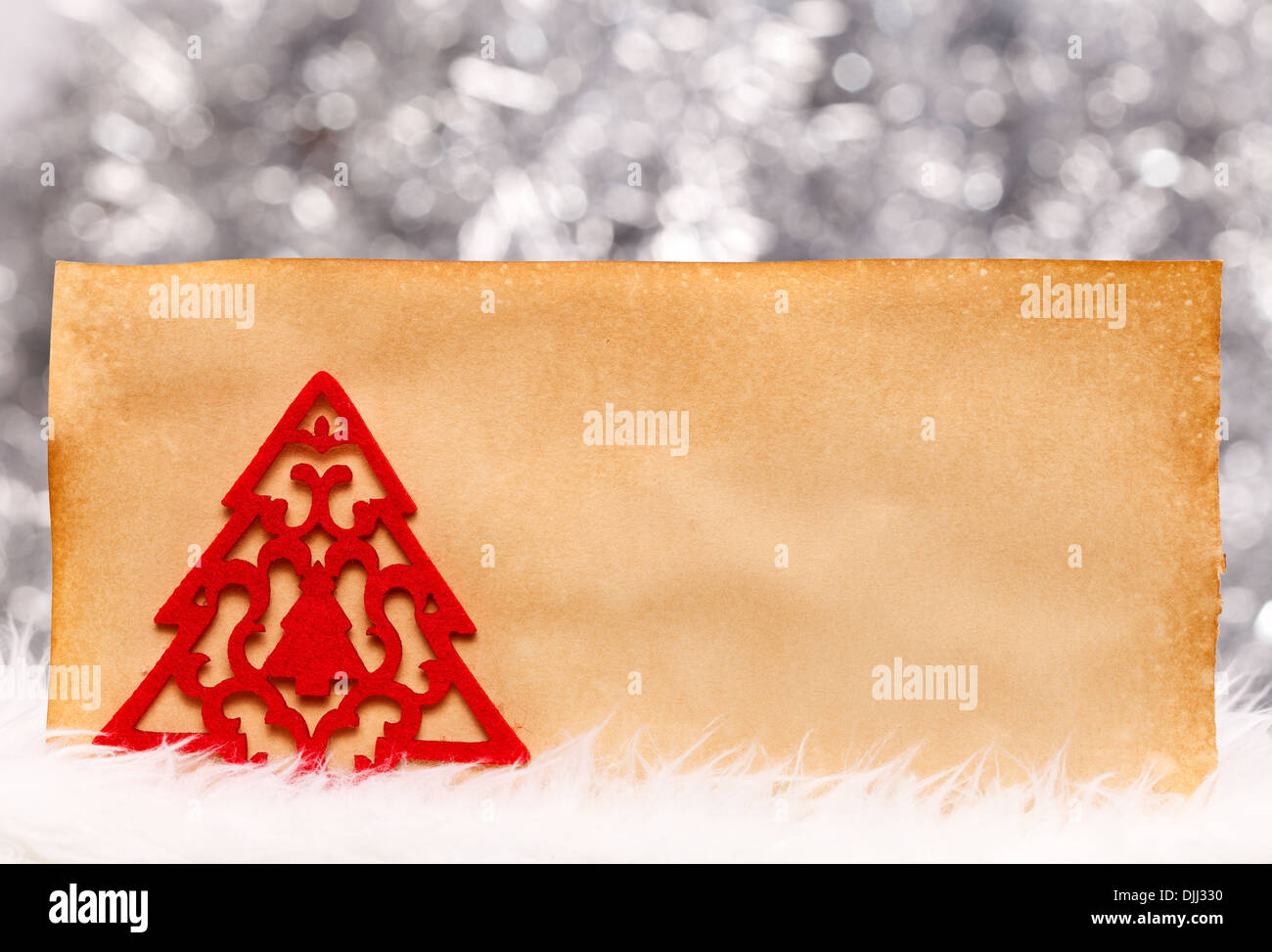 Red fleece Christmas tree in old paper. Gray-silver blurry christmas ...