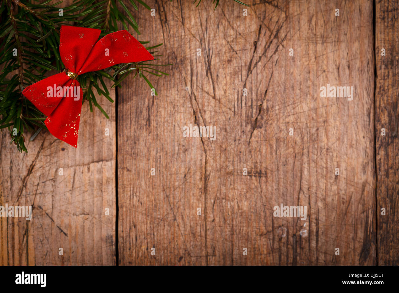 Wooden background with green branch and small red ribbon on it Stock ...
