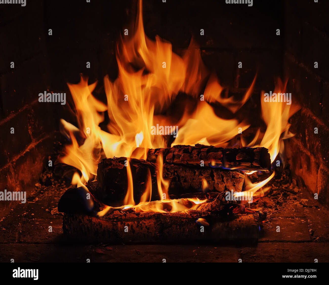Fireplace with birch firewood and flame. Closeup Stock Photo - Alamy