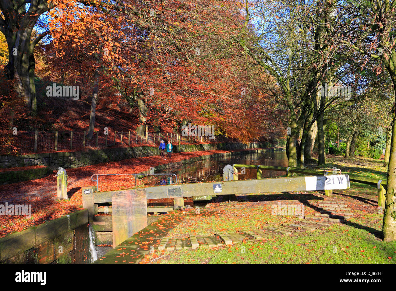 Two walkers enjoying autumn on the Huddersfield Narrow Canal, Uppermill ...