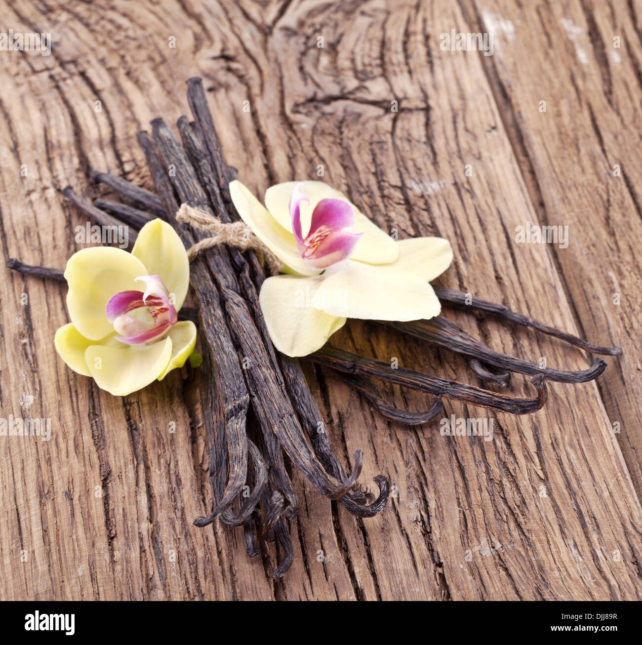 Vanilla sticks with a flower on a wooden table Stock Photo - Alamy