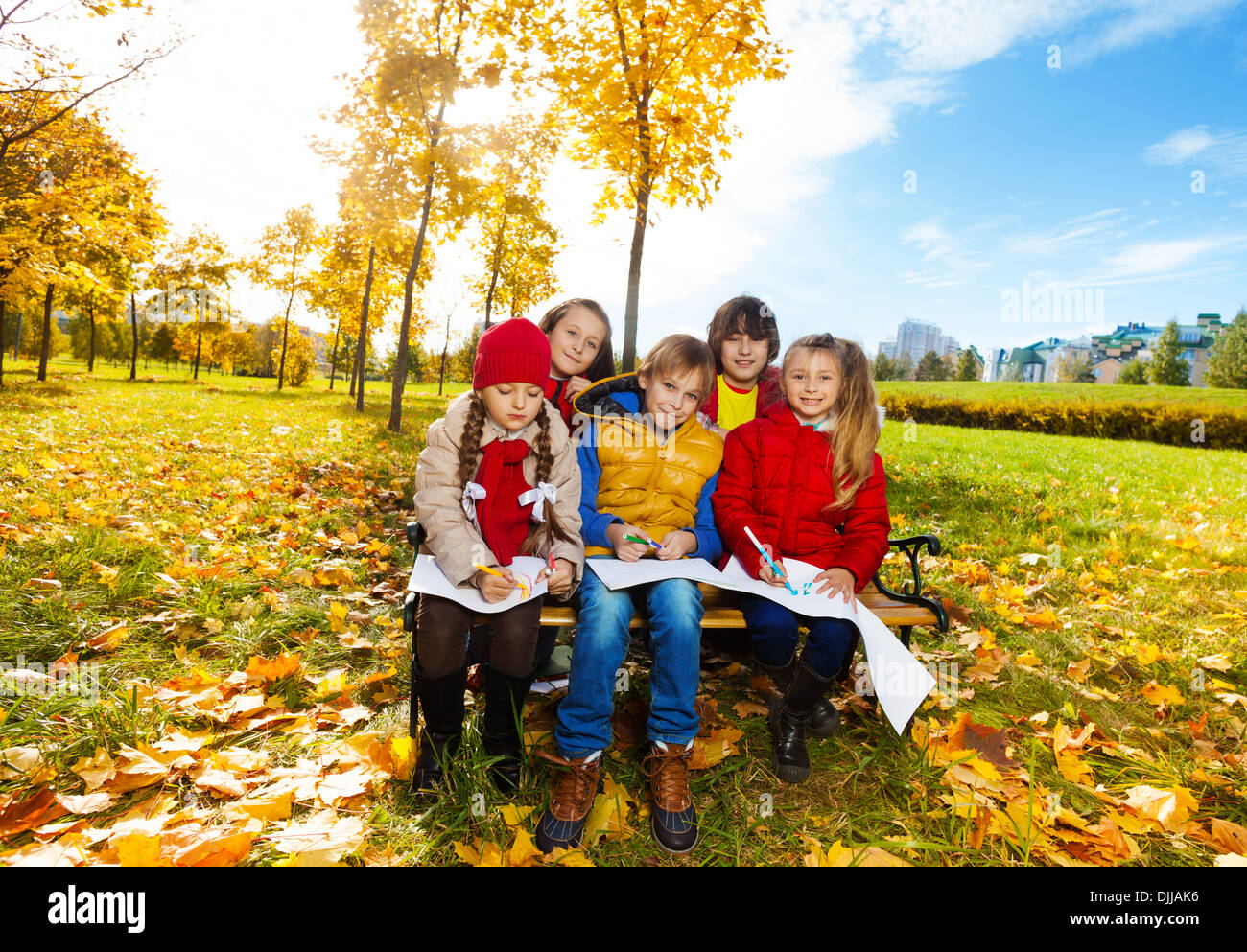 Group of smiling happy kids friends, boys and girls sitting on the ...