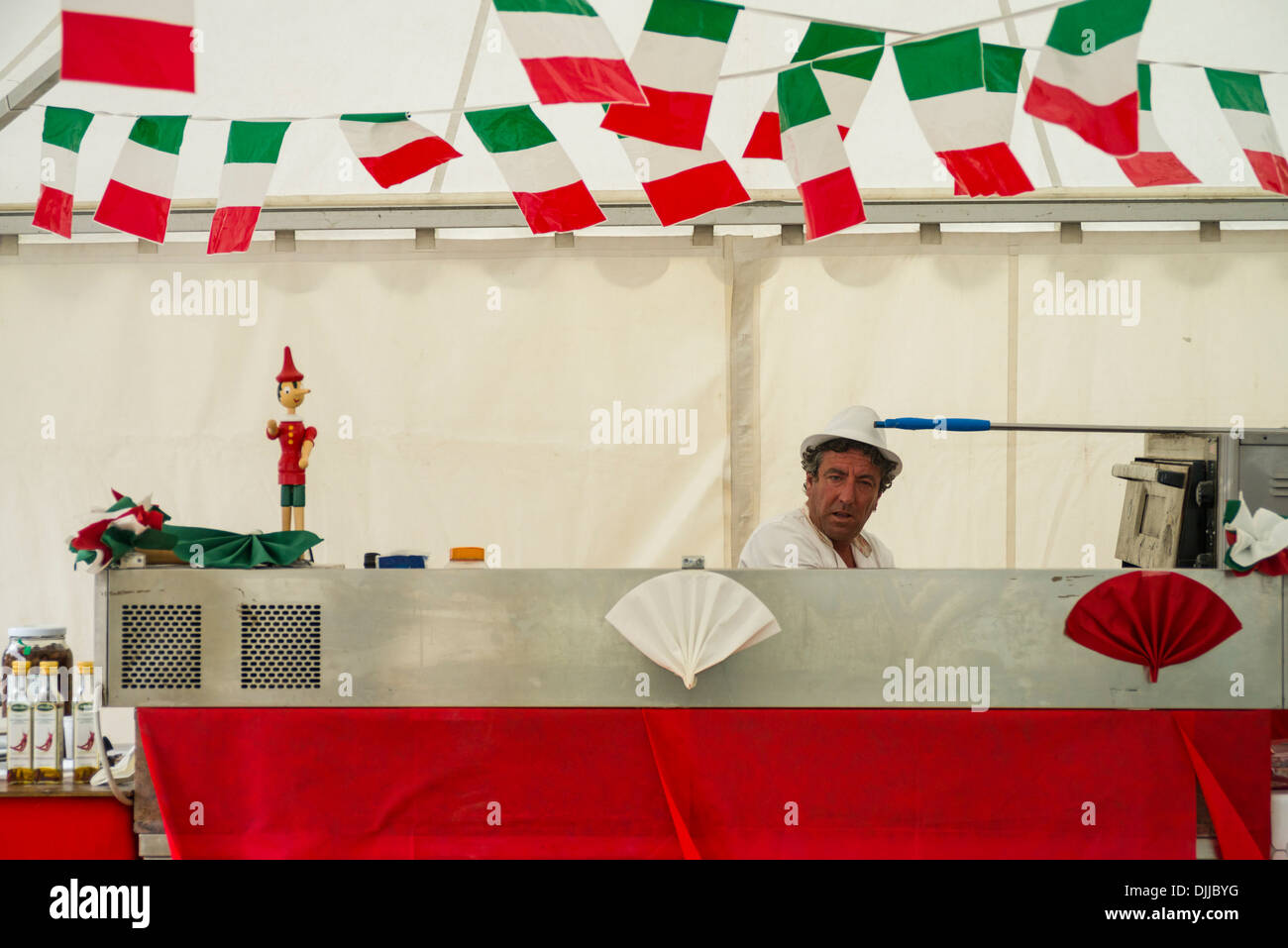 Pizzaiolo at work preparing pizza, horn and pinocchio Stock Photo - Alamy