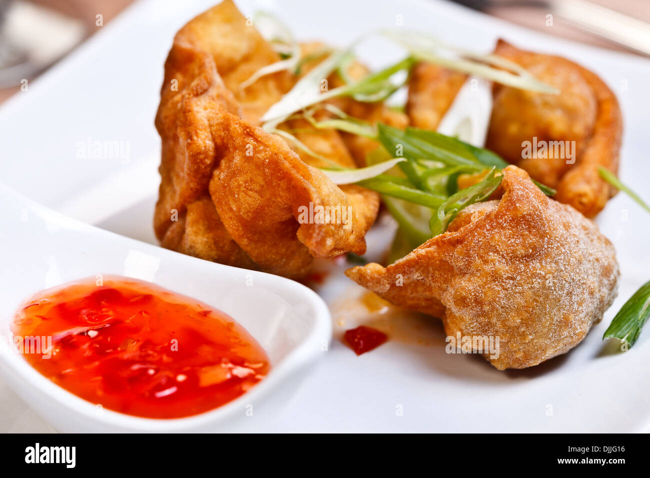 Thin flour sheet stuffed with seasoned chicken and deep fried, served ...