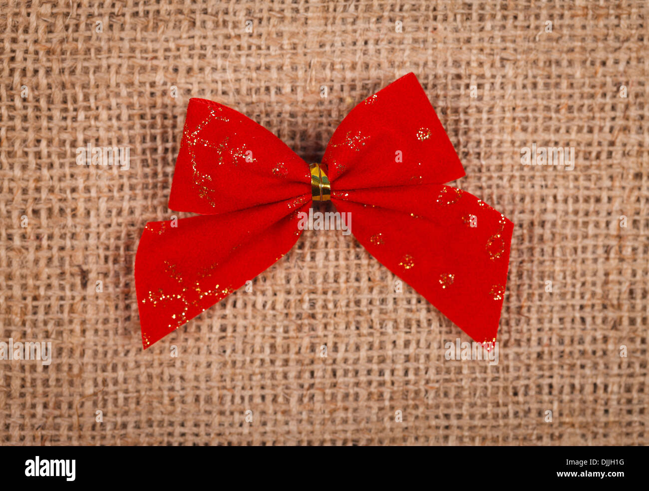 Small red ribbon on burlap background, Christmas concept Stock Photo ...