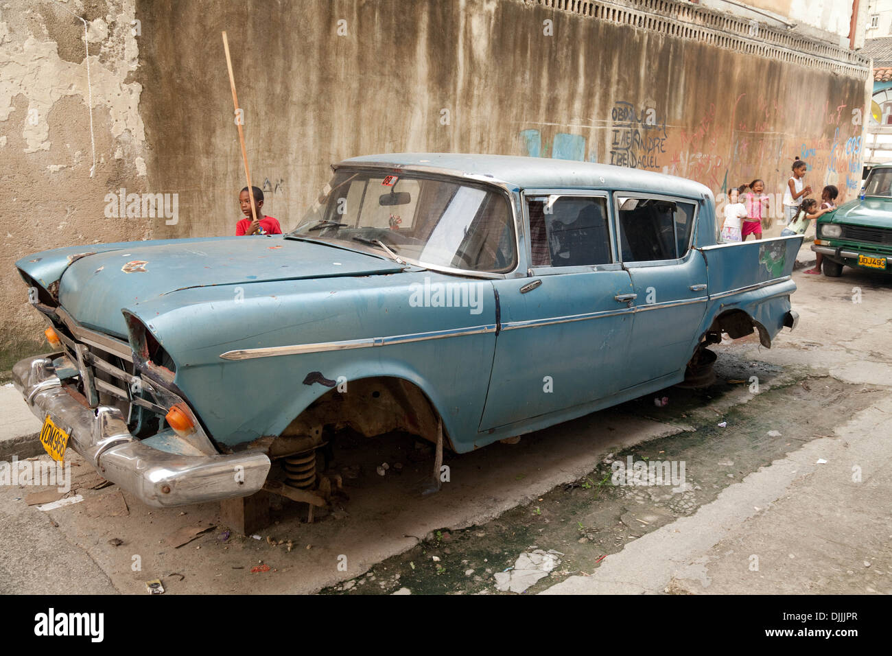 An old american car on piles of bricks - poverty in a poor area of ...