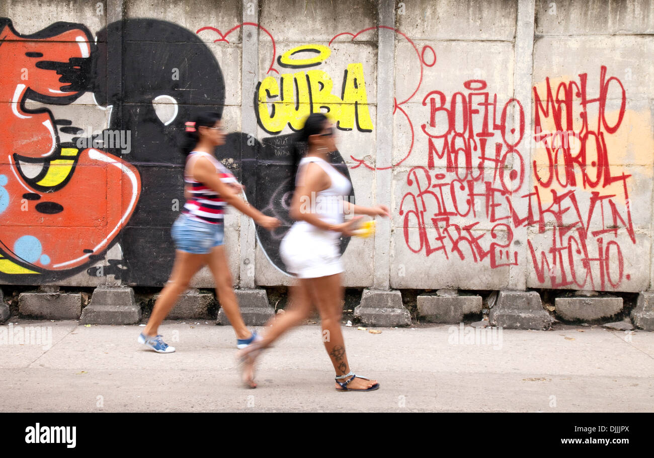 Local cuban women walking past graffiti, Havana Cuba street scene ...