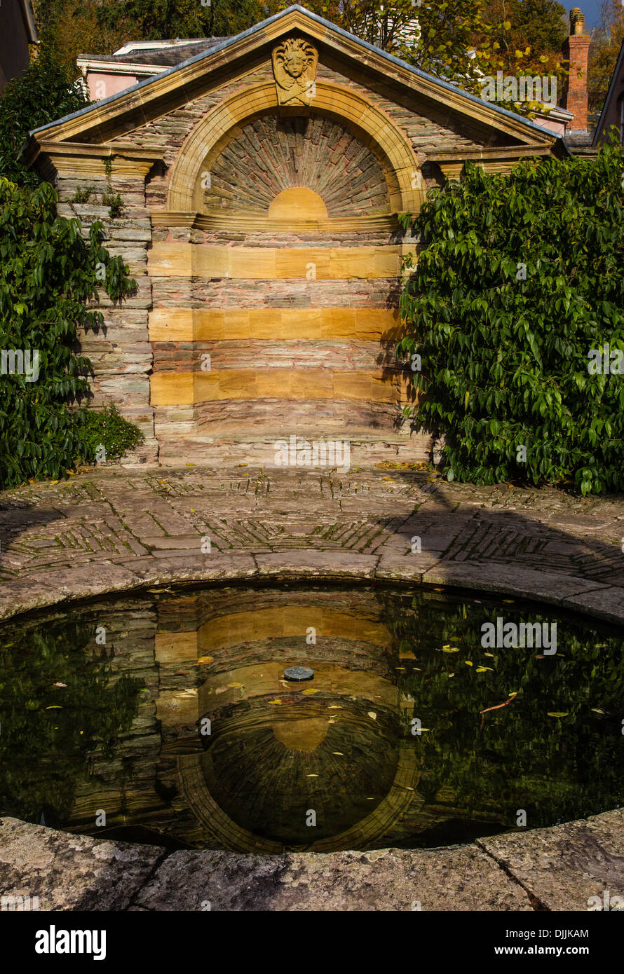 Circular pond and niched portico banded limestone and Ham stone ...