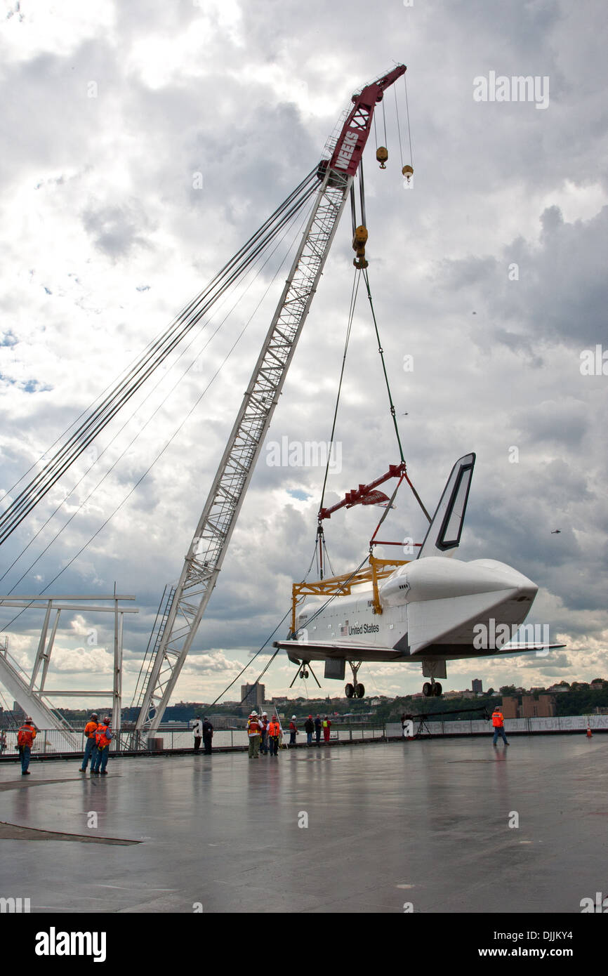 The NASA space shuttle prototype Enterprise is lowered by crane into ...
