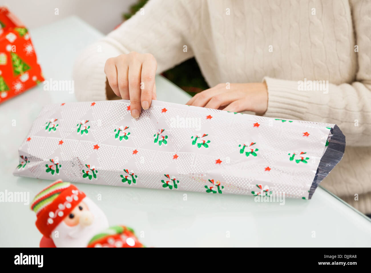 Woman Wrapping Christmas Gift Stock Photo - Alamy