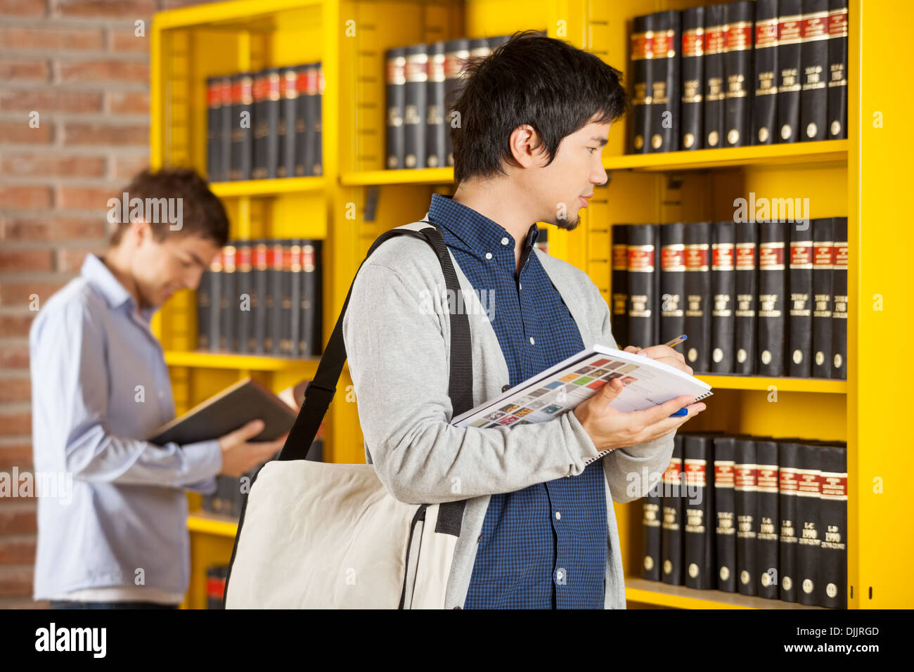 Asian holding library books hi-res stock photography and images - Alamy