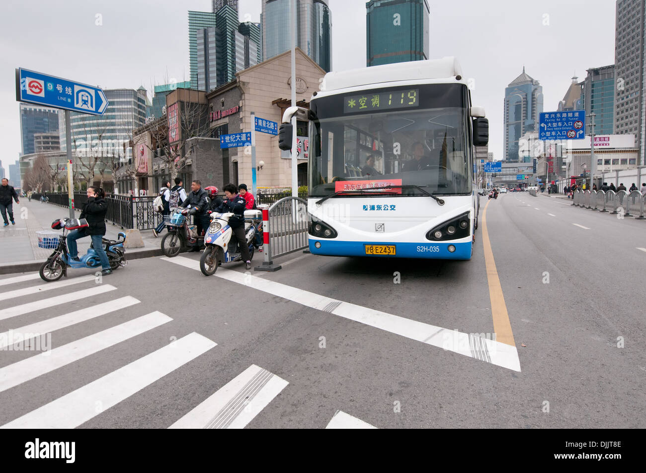 Bus and people on scooters in Lujiazui area, Pudong District, Shanghai ...