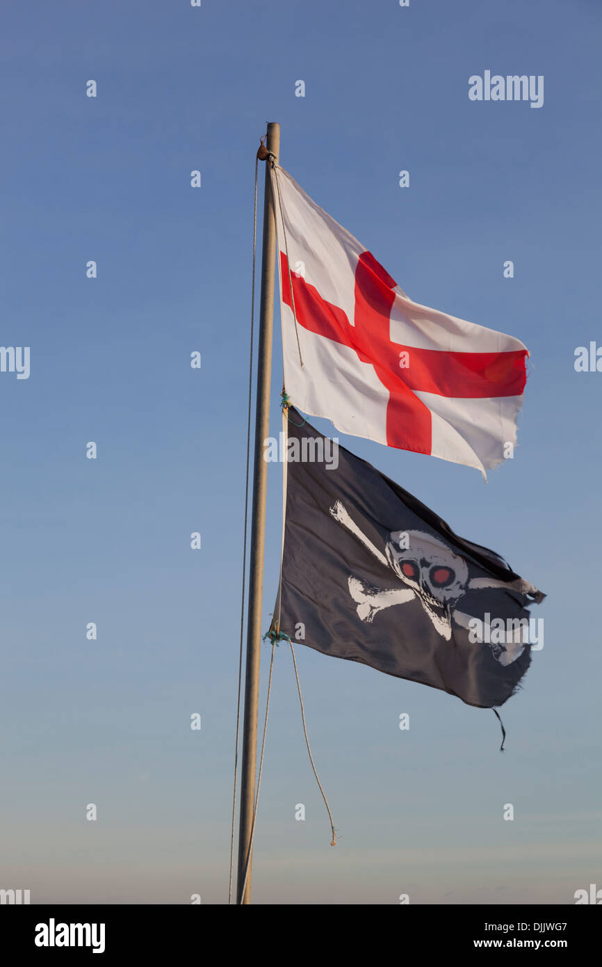 Flag of St George and the 'Jolly Roger' pirate flag fly from a flag ...