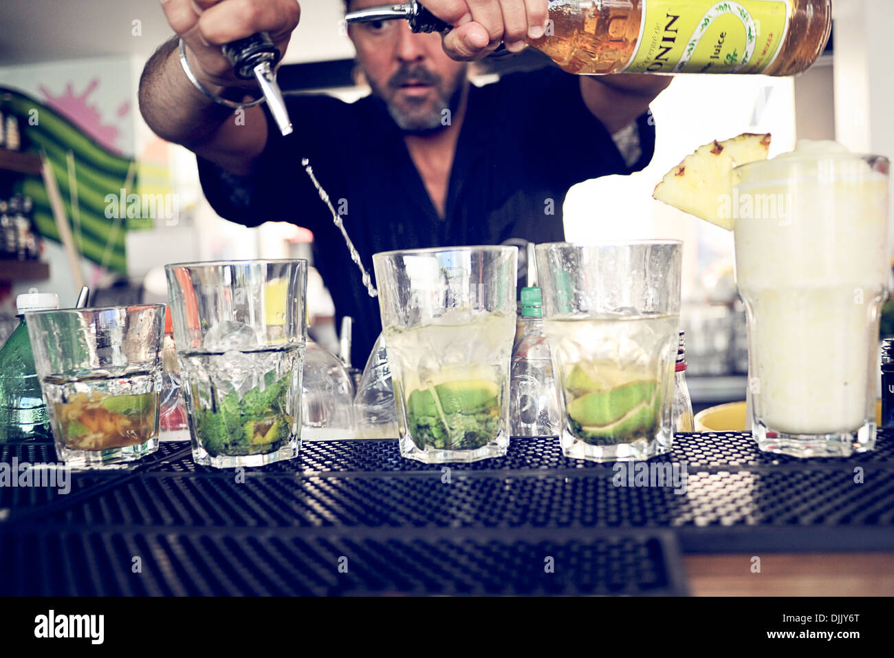 Barman pouring cocktails Stock Photo - Alamy