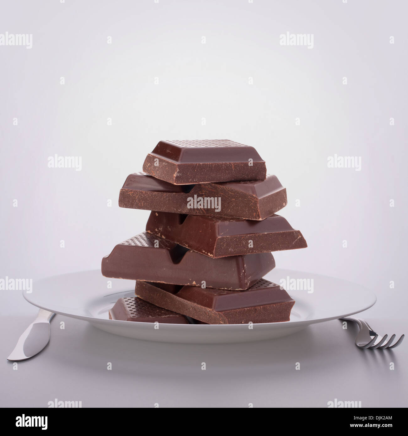 Chocolate bars stack on plate. Unhealthy eating concept Stock Photo - Alamy