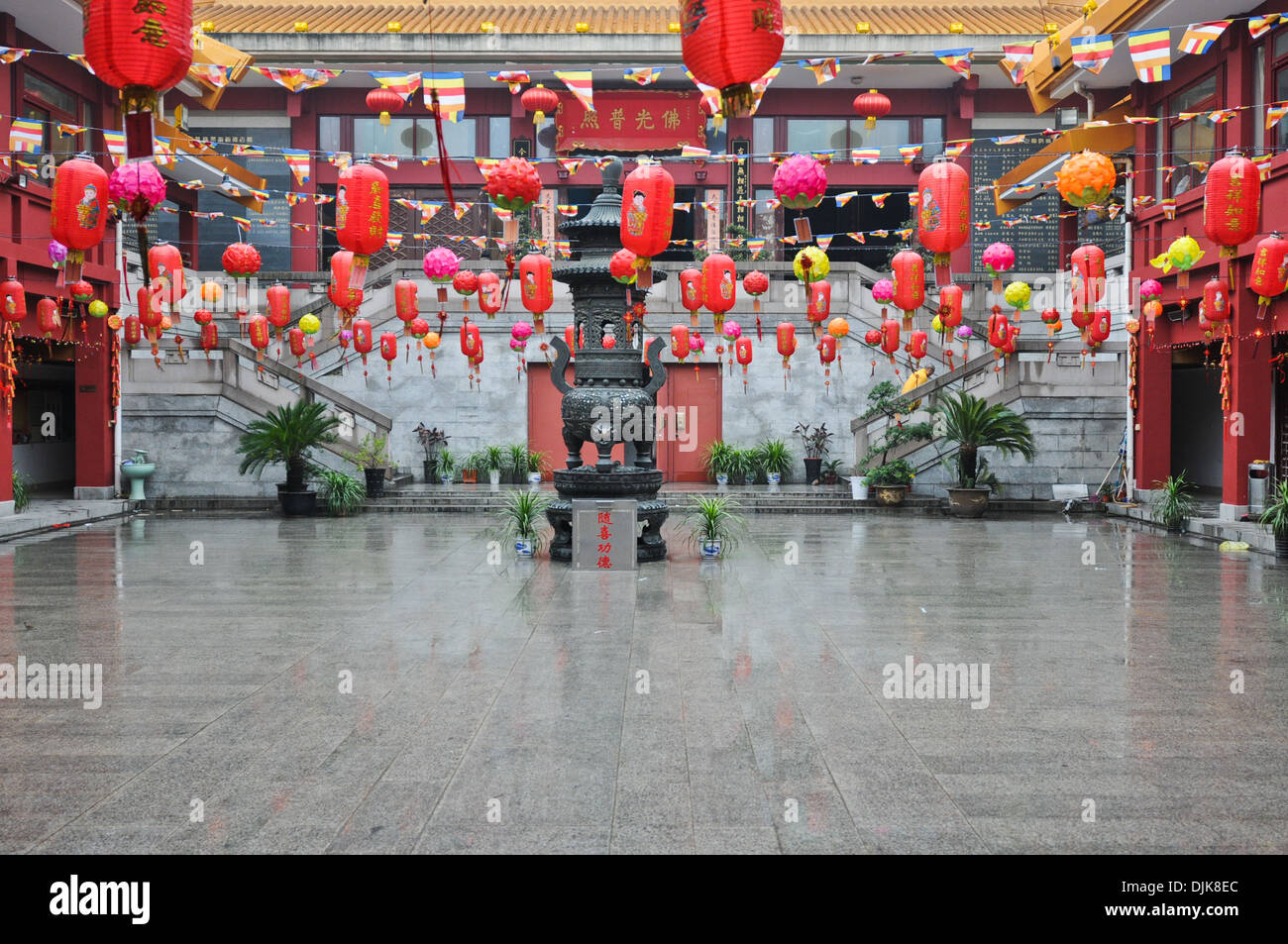 Courtyard with Incenses burner and red chinese lanterns in Qibao Temple ...