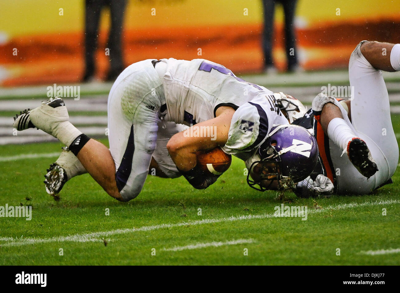 11 Northwestern Wide Receiver Jeremy Ebert hits the turf after being ...
